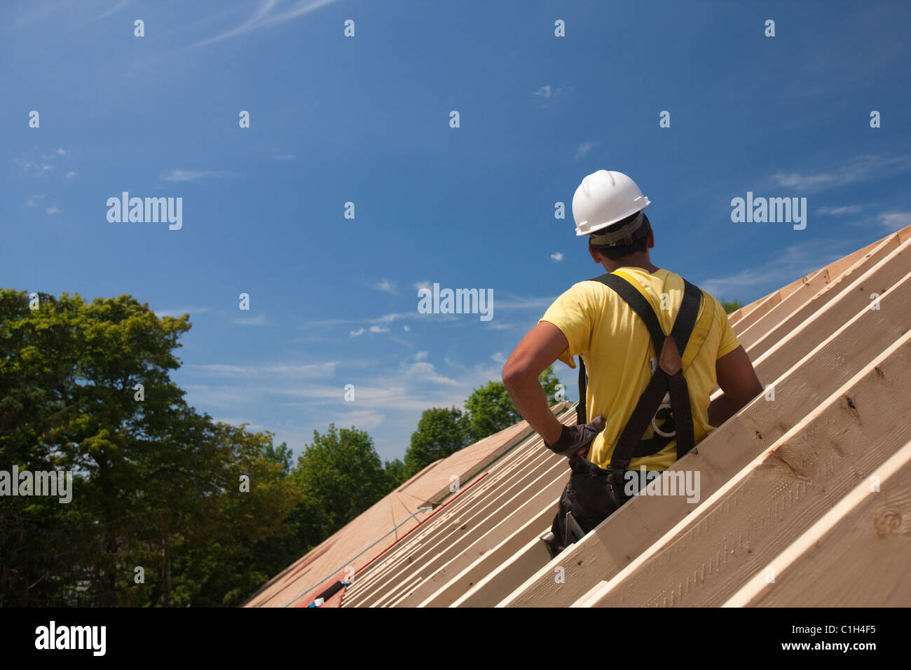 Hispanic carpenter resting on the roof construction of a house Stock ...