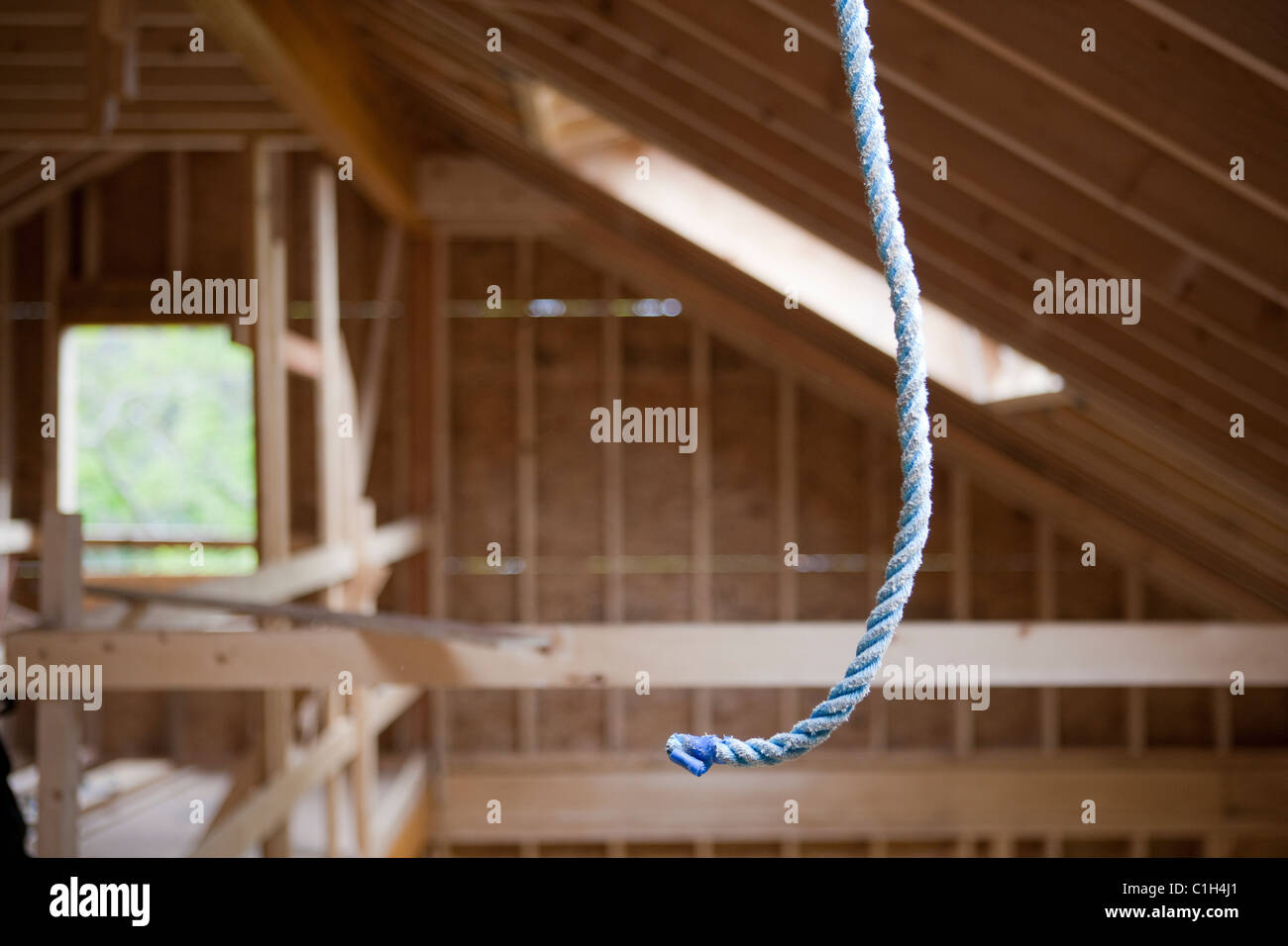 Safety rope hanging at a house under construction Stock Photo - Alamy