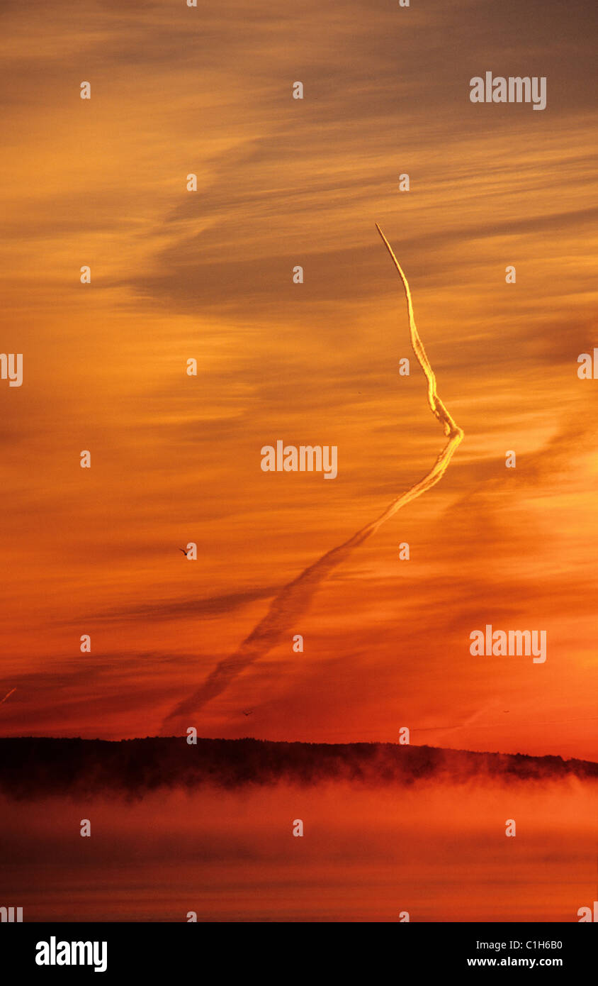 Canada, Quebec Province, sky set ablaze by the rising of the sun to the ...
