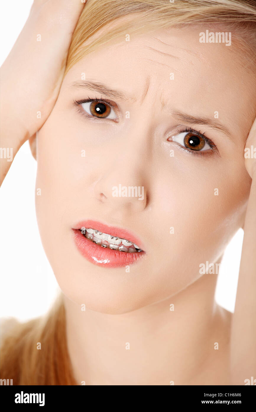 Woman with headache holding her hand to the head, isolated on white ...