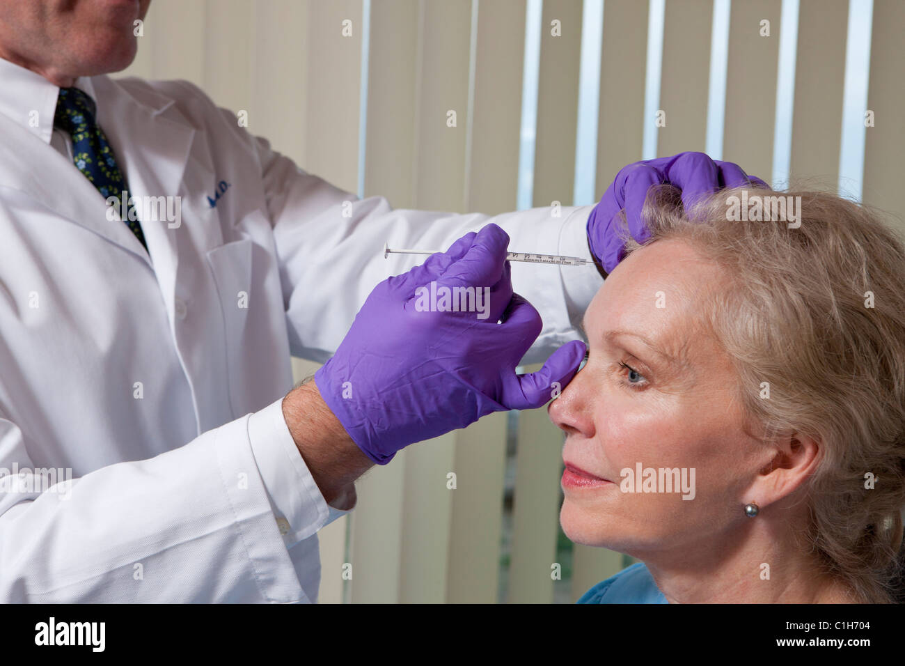 Ophthalmologist giving a Botox injection to a patient Stock Photo - Alamy