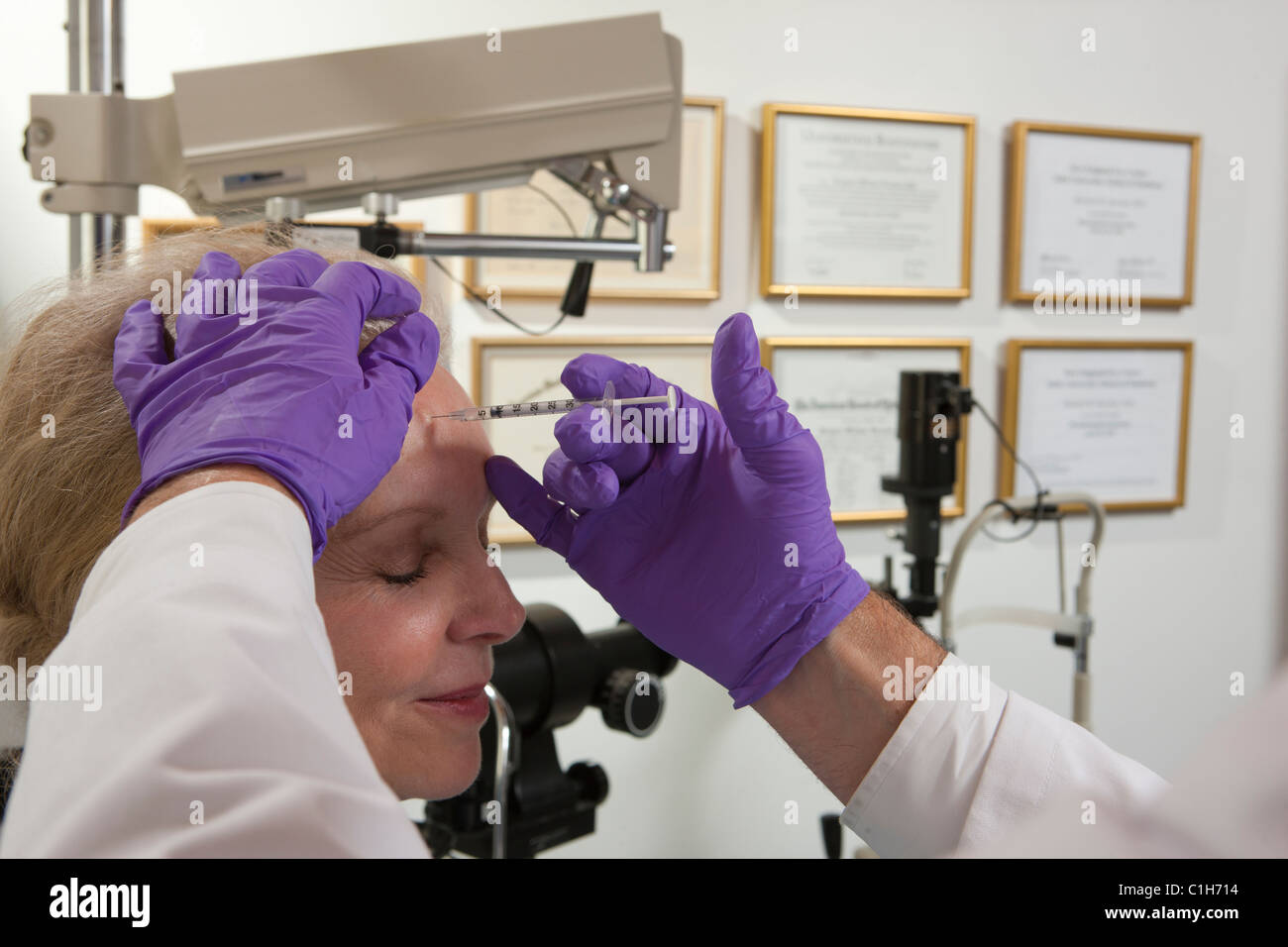 Ophthalmologist giving a Botox injection to a patient Stock Photo - Alamy