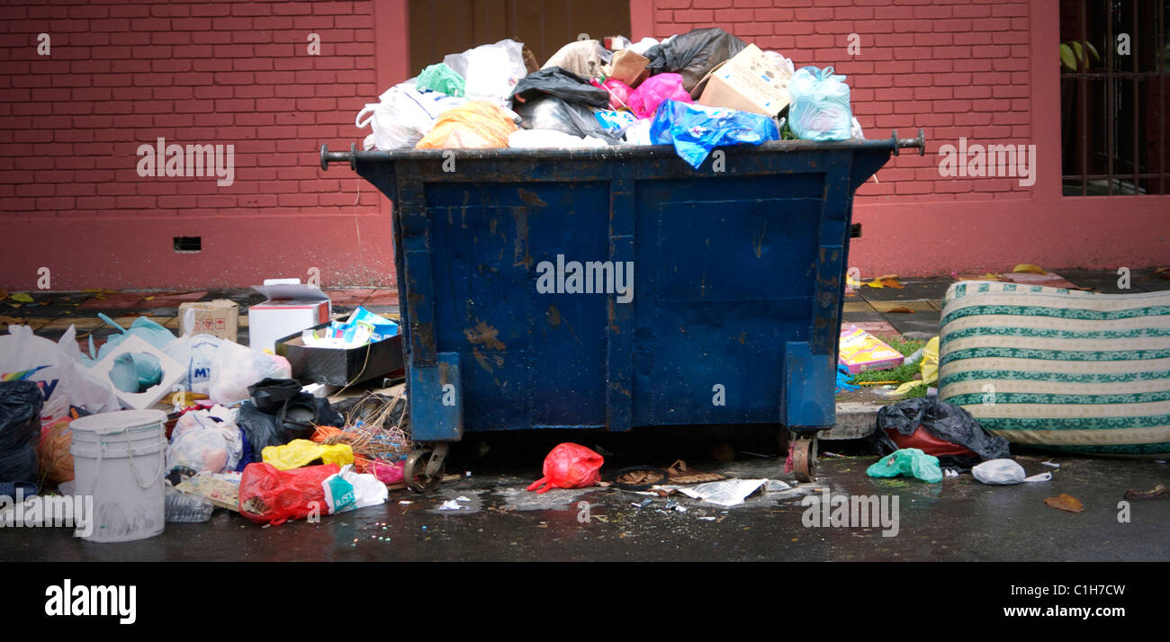 Overflowing rubbish skip hi-res stock photography and images - Alamy