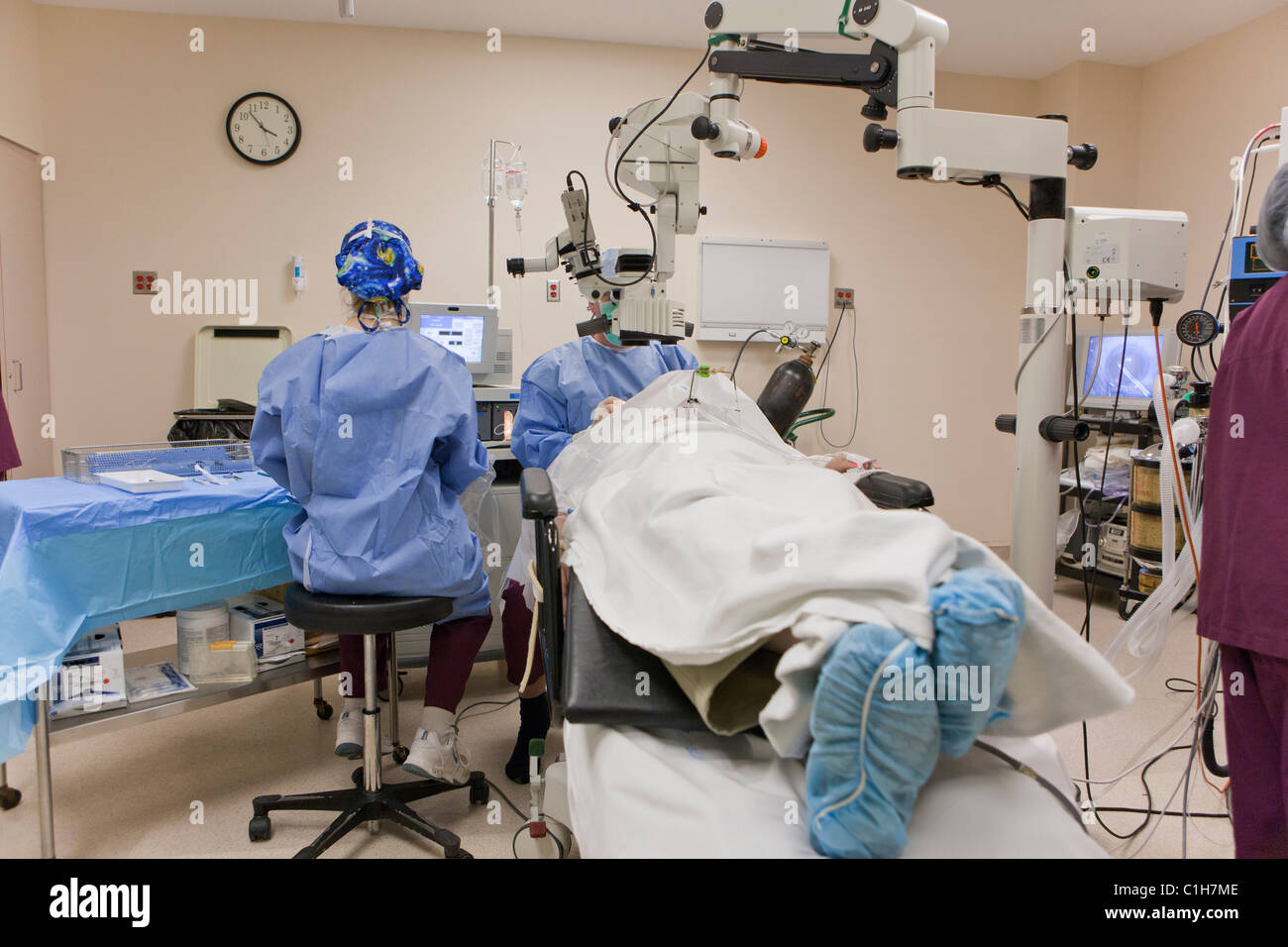 Ophthalmologist performing cataract surgery with surgical technologist ...