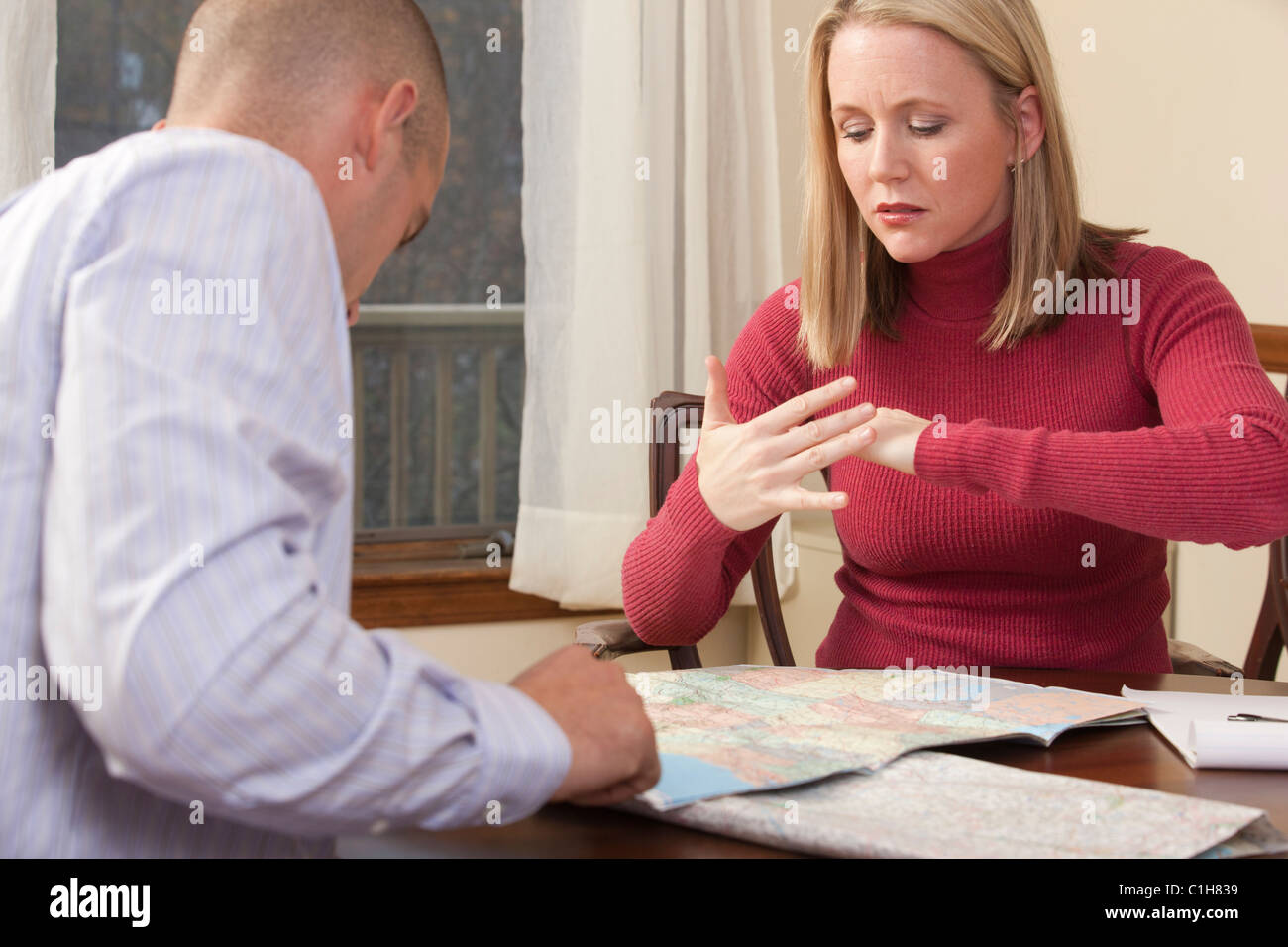 Woman signing the word 'Beach' in American Sign Language while looking ...