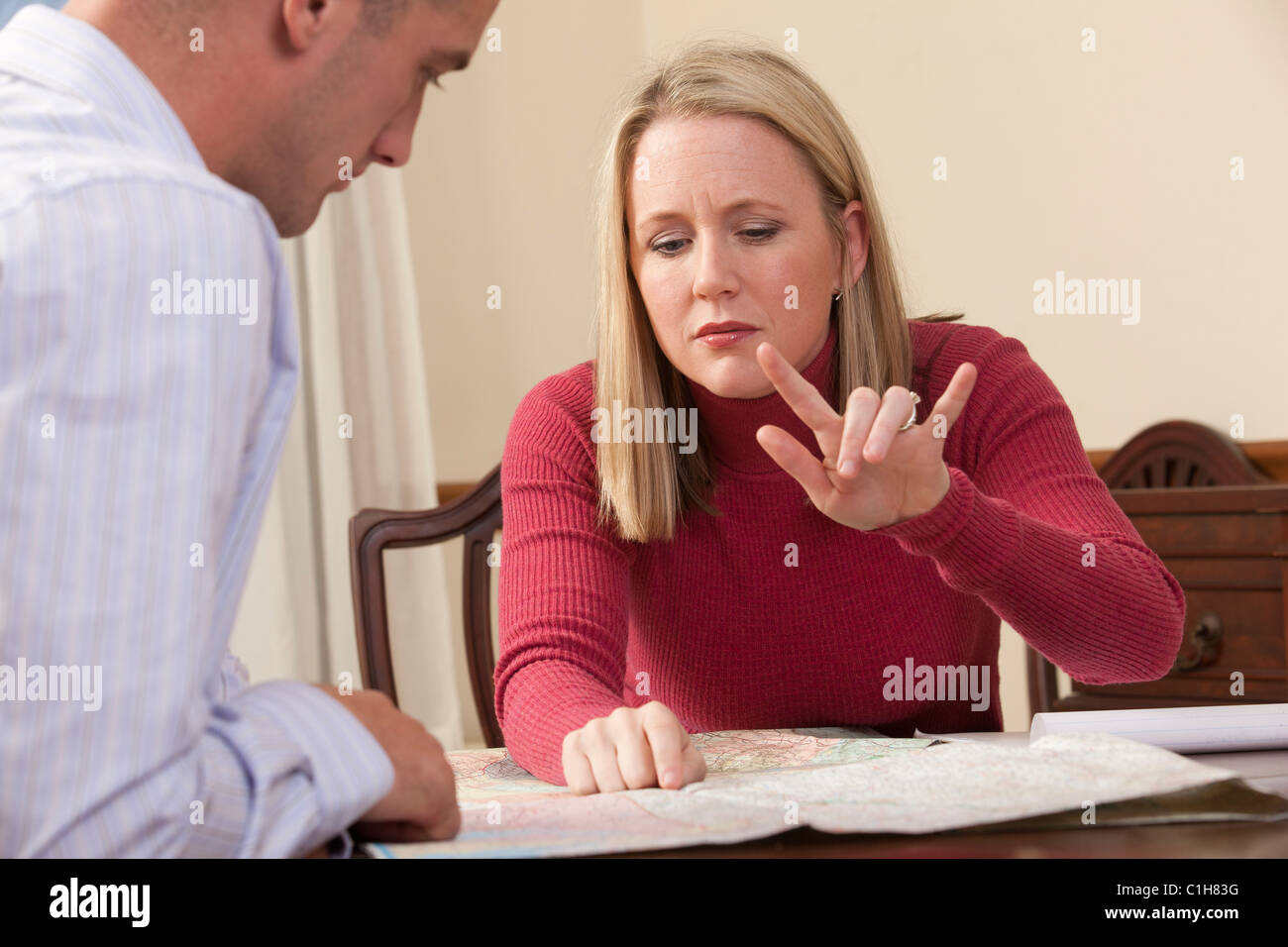 Woman signing the word 'Fly' in American Sign Language while looking at ...