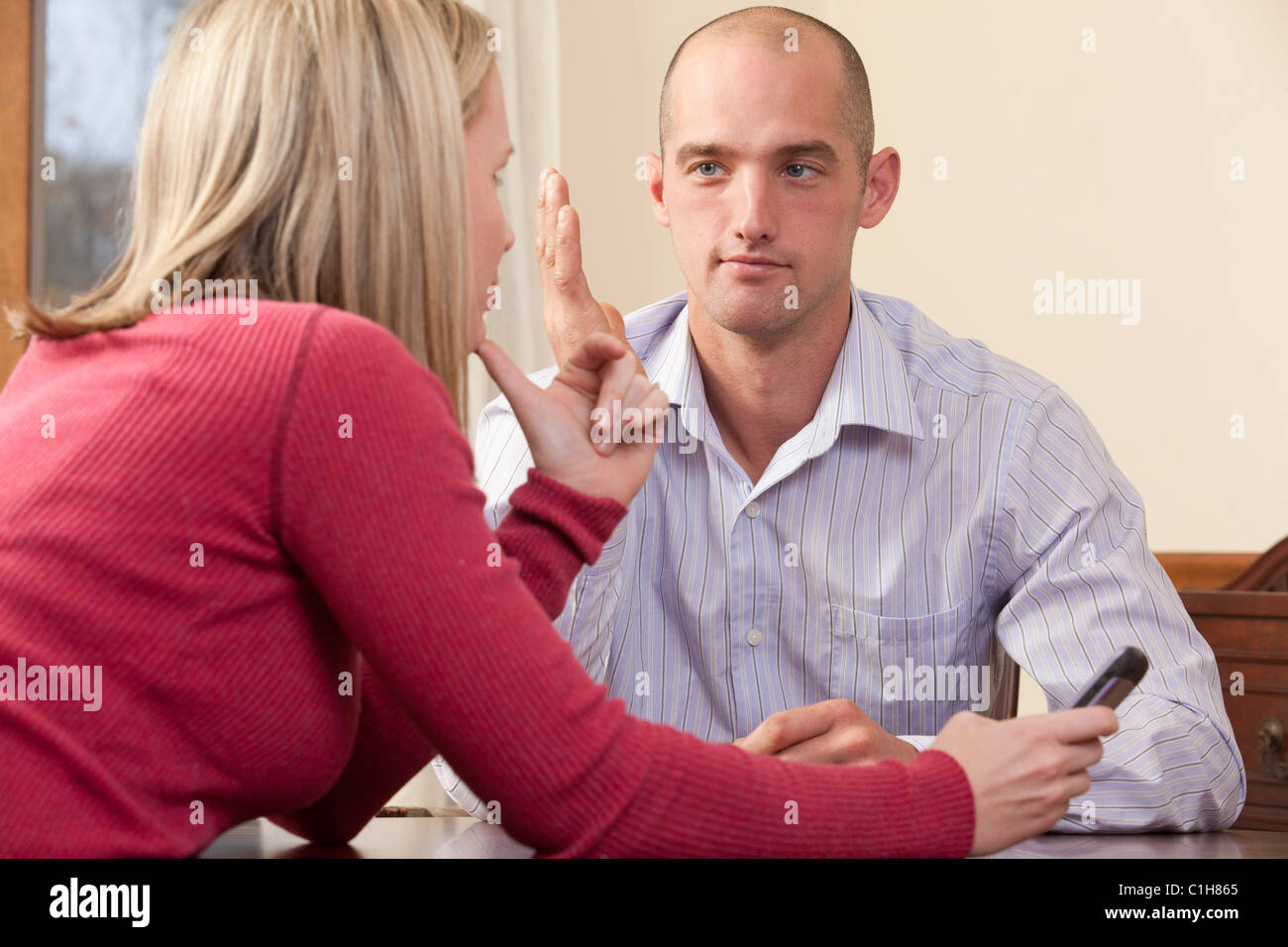 Woman signing the word 'Show' in American Sign Language with a man ...