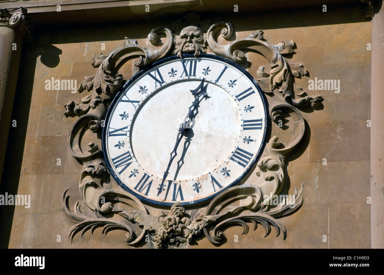 clock face with green man on surrounding metalwork at the industrial ...