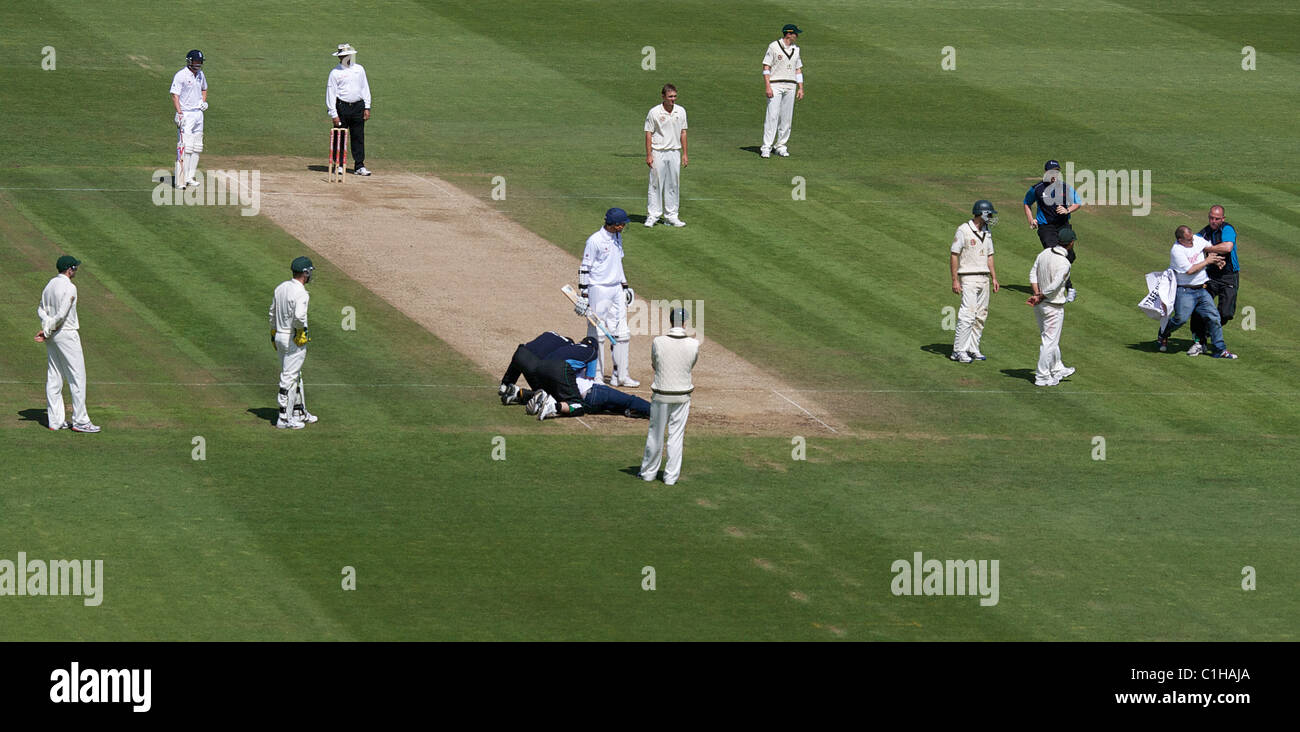 Pitch invaders are dealt with by security during the England V ...