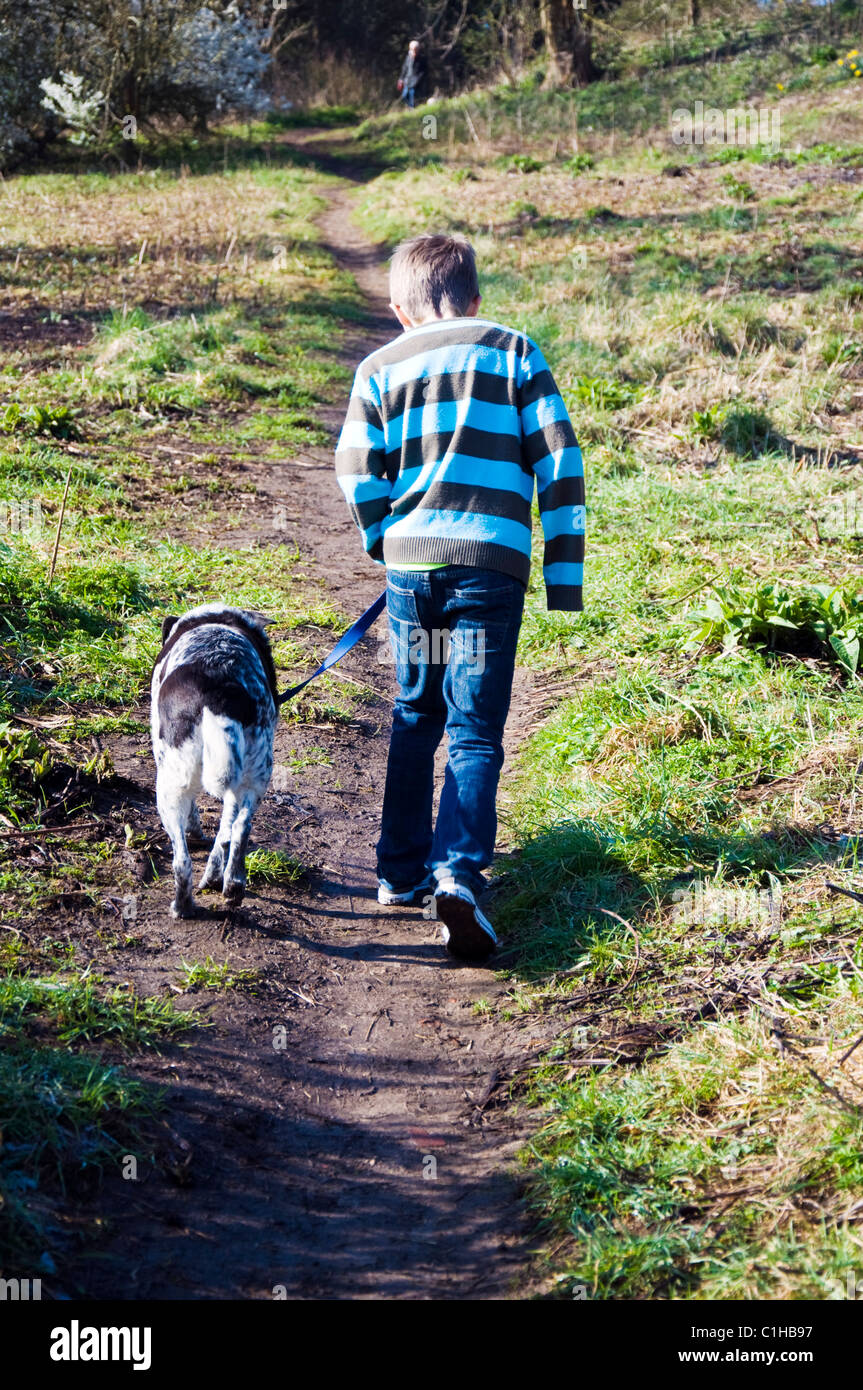 Boy walking his dog Stock Photo - Alamy