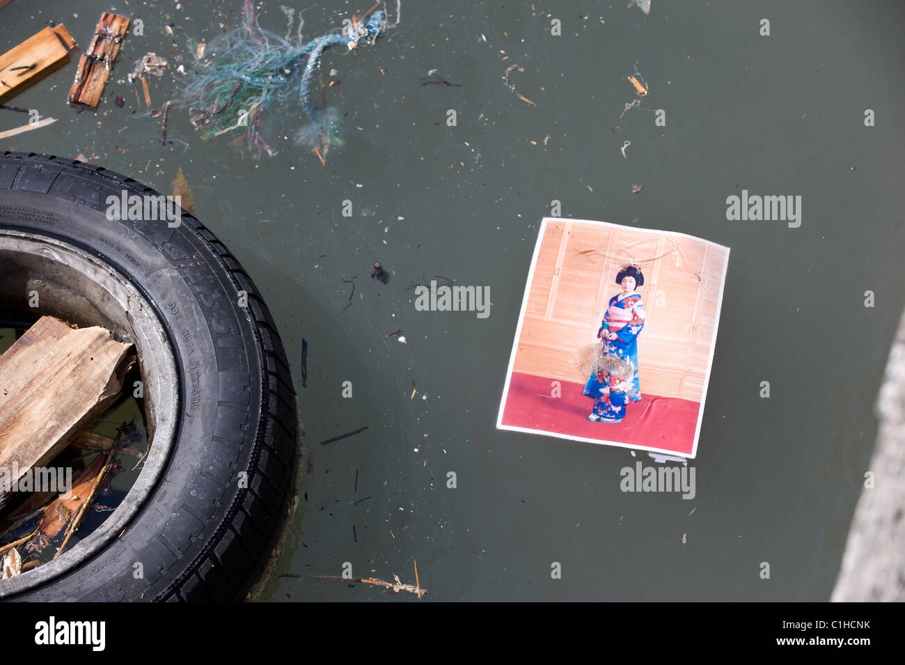 A photo of a kimono-clad woman floats next to a tire in the bay at ...