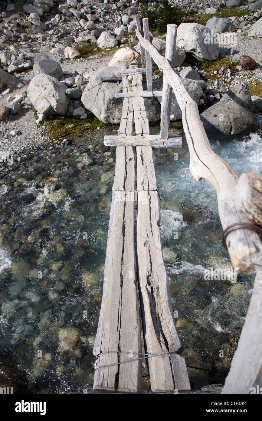 Narrow bridge over small river Stock Photo - Alamy