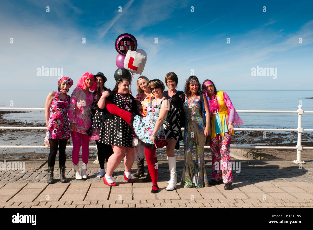 A Group Of Women Dressed In Fancy Dress 1970s Clothes On A Batchelorette Hen Party In