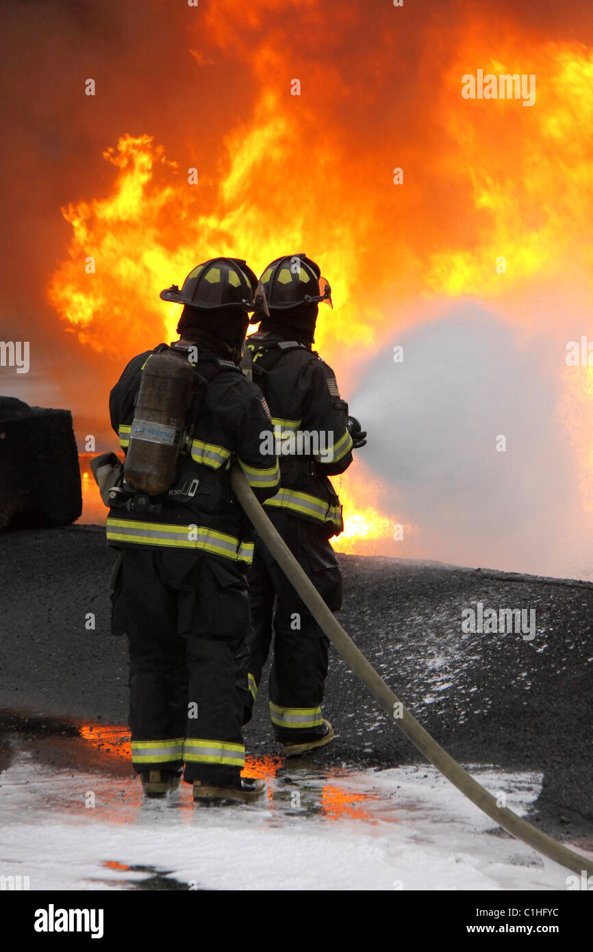 Firefighters fighting fire at an ARFF training drill at the Washington ...