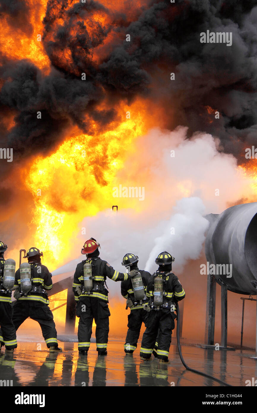 Firefighters fighting fire arff training hi-res stock photography and ...