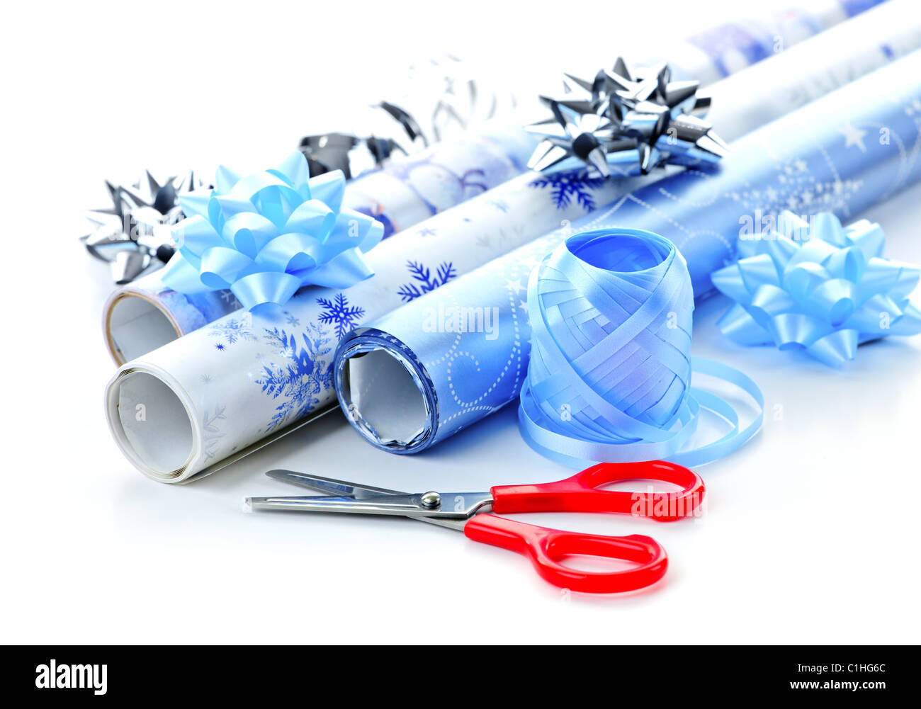 Rolls of Christmas wrapping paper with ribbons, bows and scissors Stock ...