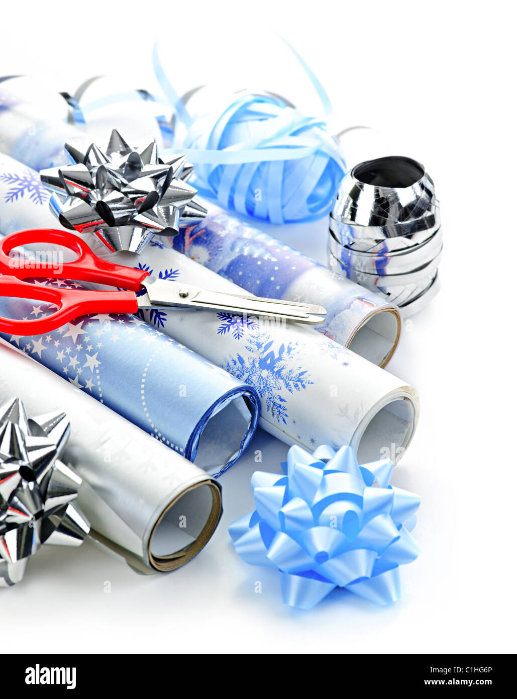 Rolls of Christmas wrapping paper with ribbons, bows and scissors Stock ...