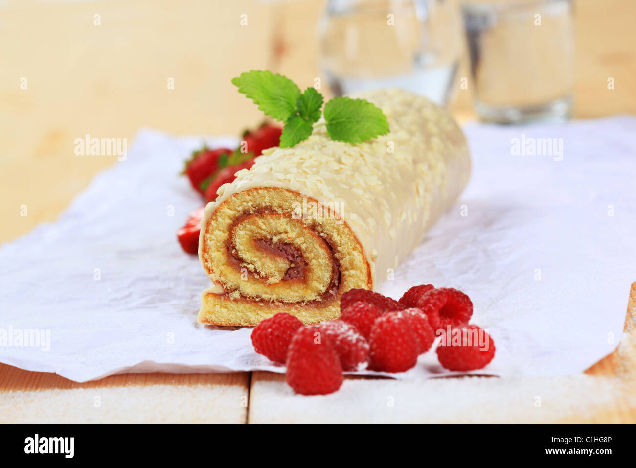 Swiss roll glazed with white chocolate icing Stock Photo - Alamy