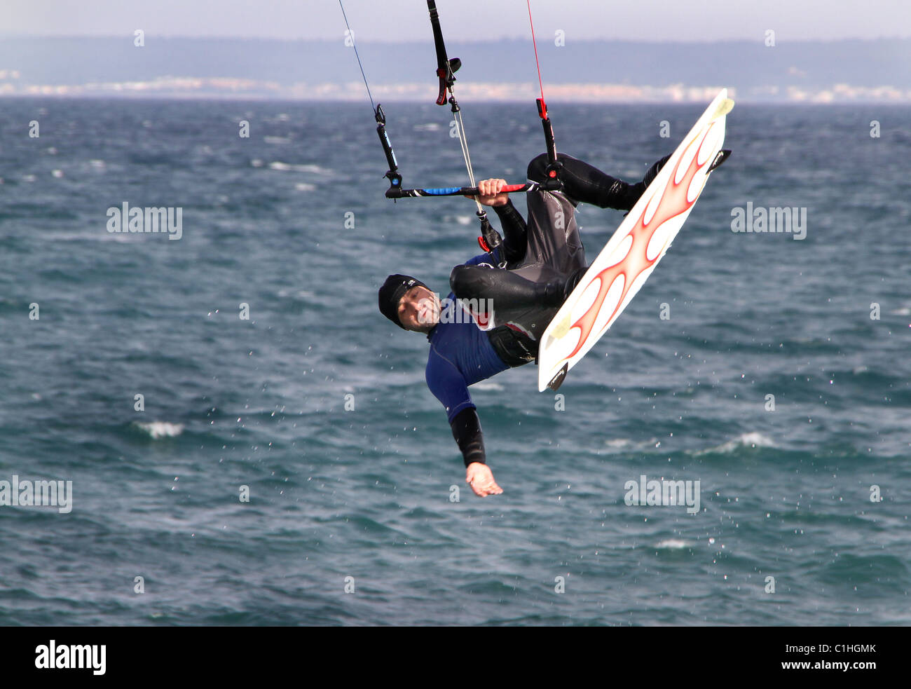 Man doing tricks while kite wind surfing Stock Photo - Alamy