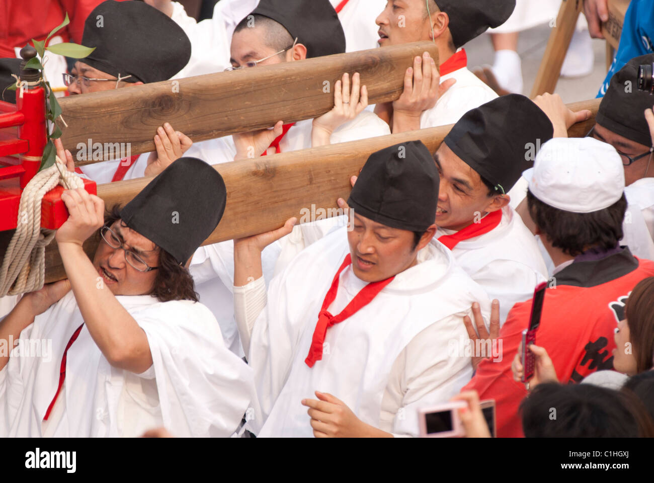 Participants carrying a portable shrine carrying a model of a deity ...