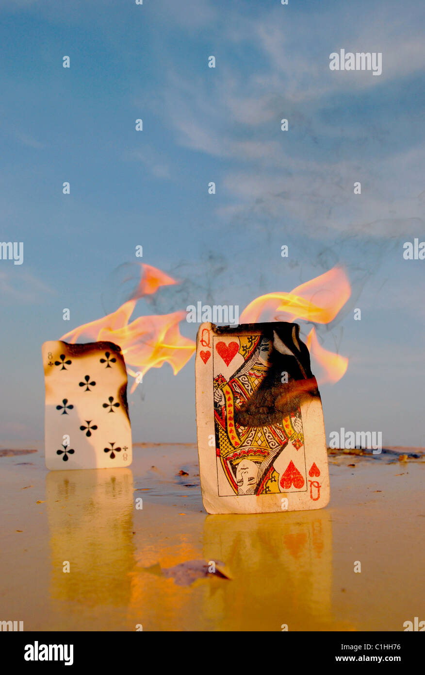 Two burning cards on sky background with fire and smoke Stock Photo - Alamy