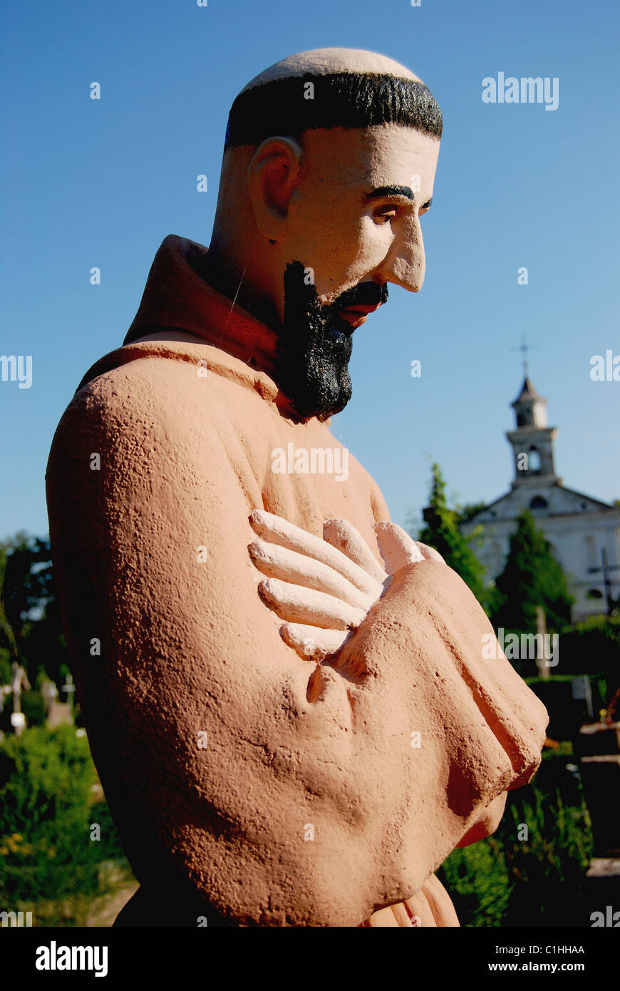 Retro monk sculpture with hands Stock Photo - Alamy