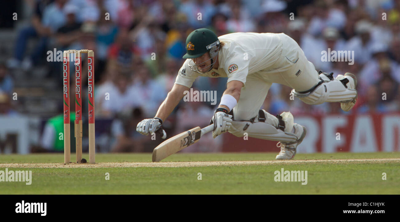 Shane Watson dives in to survive a missed throw at the stumps during ...