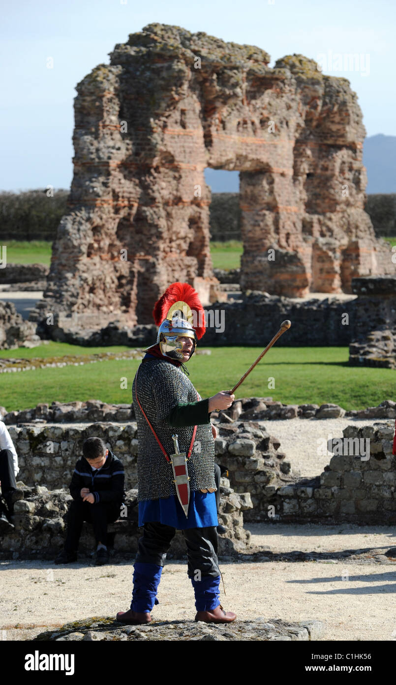 A guide wearing Roman uniform talking to school children at Wroxeter or ...