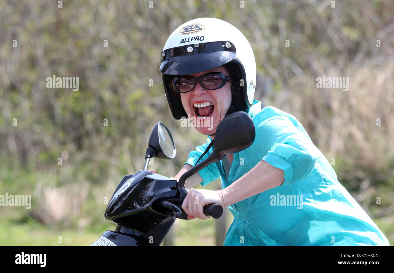 A woman having fun riding a scooter.. Picture by James Boardman Stock ...