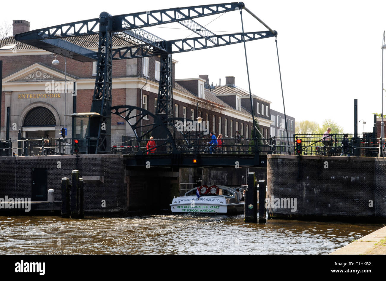 A boat going under a raising bridge over the canal in Amsterdam Stock ...