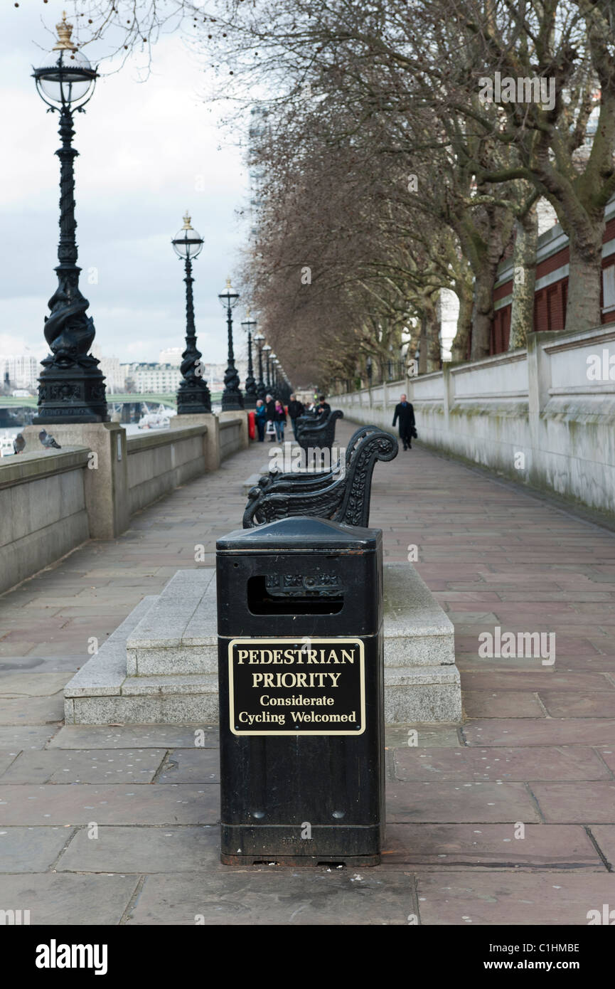 Notice advising that pedestrians have priority in front of seats on the ...