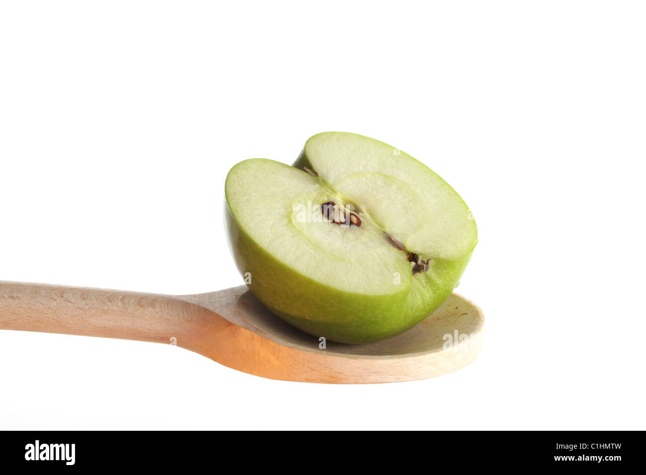 Apple on a wooden spoon isolated against a white background Stock Photo ...