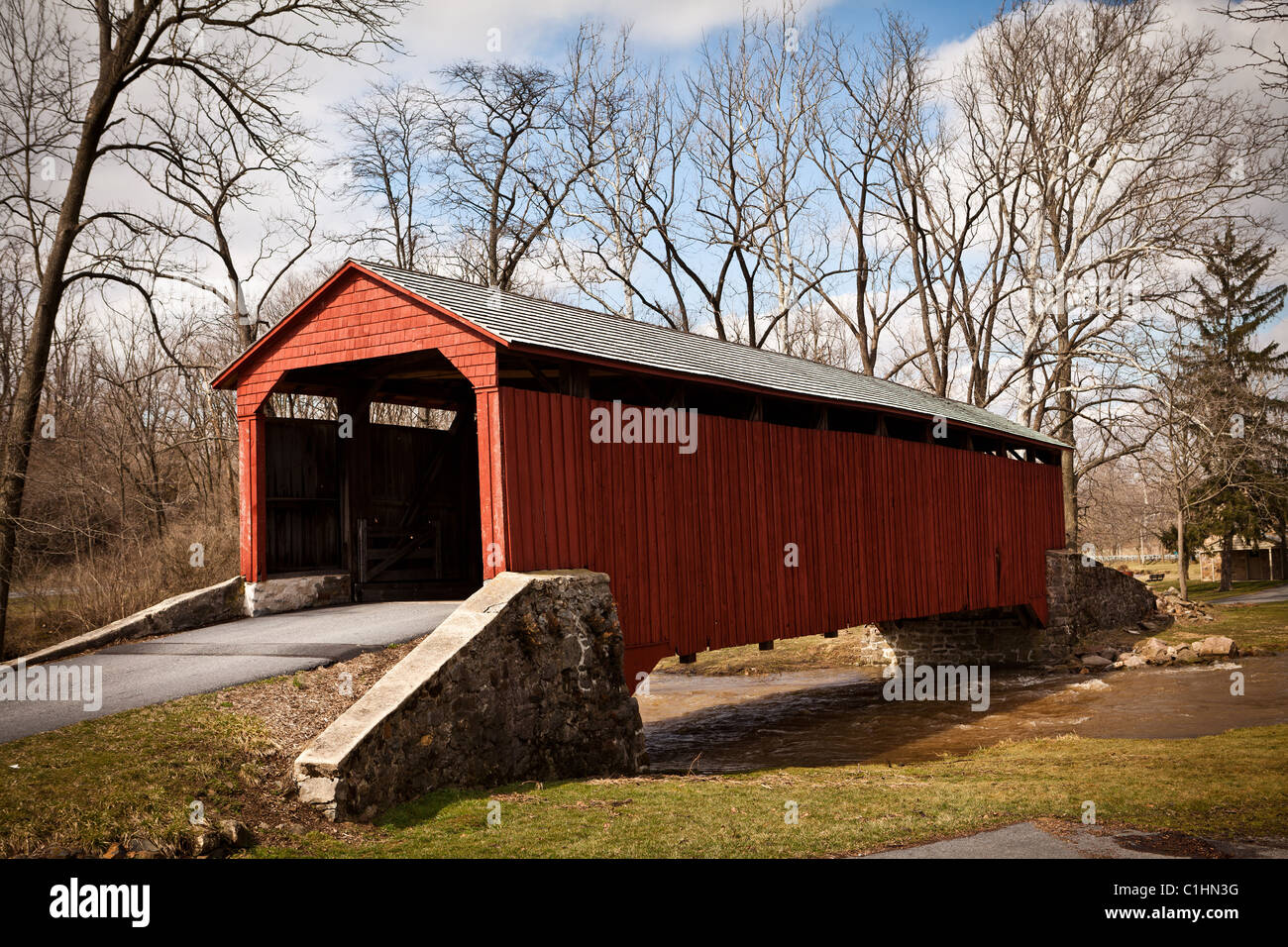 Amish women rides her bike through Pool Forge Covered Bridge Caenarvon ...