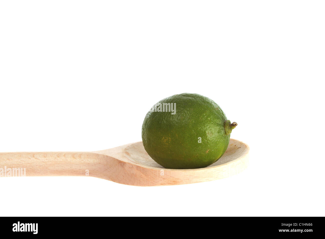 Lime on a wooden spoon isolated against a white background Stock Photo ...