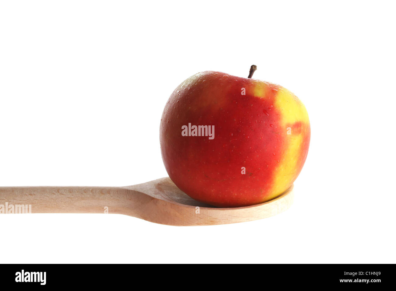 Apple on a wooden spoon isolated against a white background Stock Photo ...