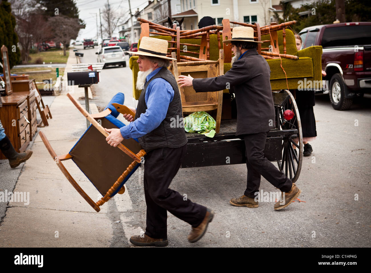Amish men unload furniture during the Annual Mud Sale to support the ...