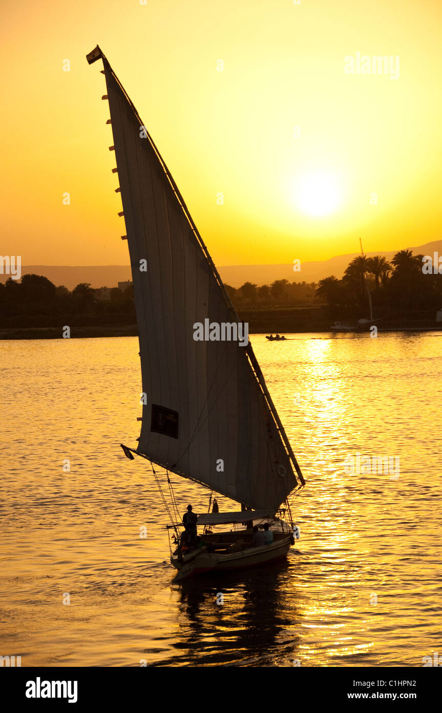 A traditional Egyptian Felucca Boat sails on the Nile in Luxor, Egypt ...
