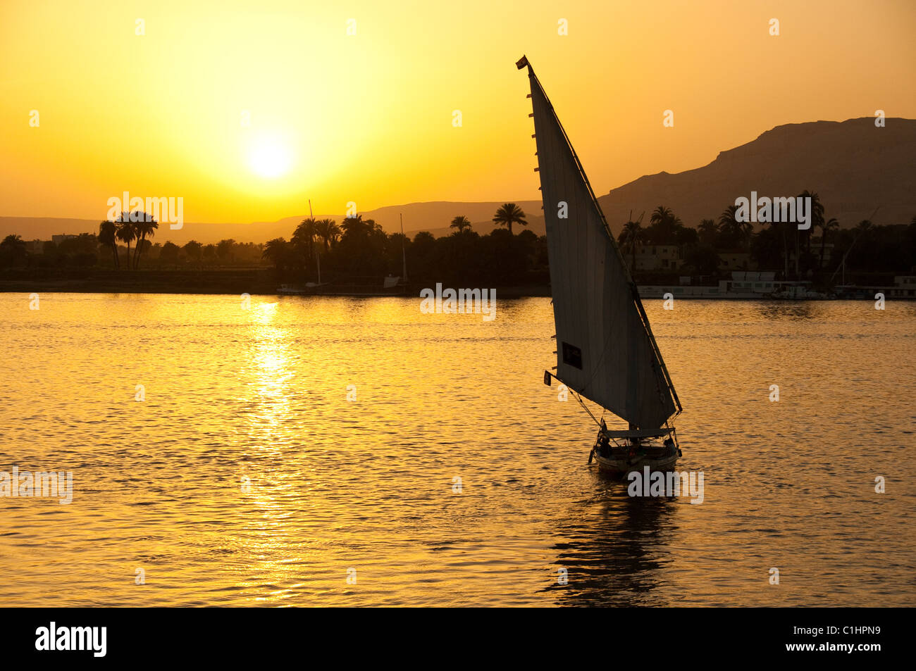 A traditional Egyptian Felucca Boat sails on the Nile in Luxor, Egypt ...