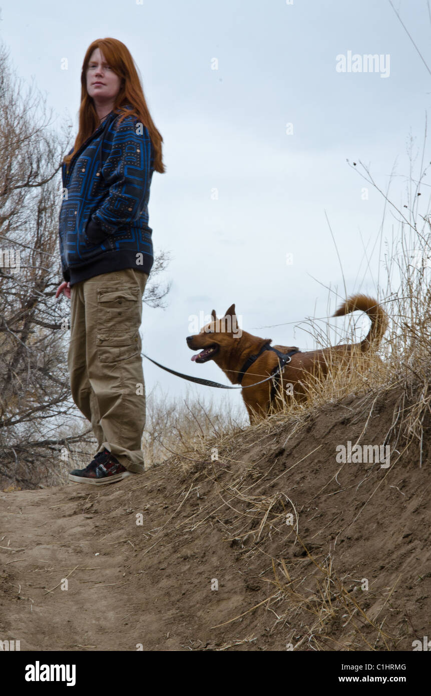 Young woman walking her dog Stock Photo - Alamy