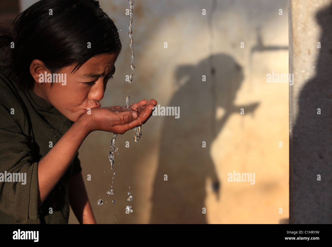 Nepali girl drinking water in Nepal Stock Photo - Alamy