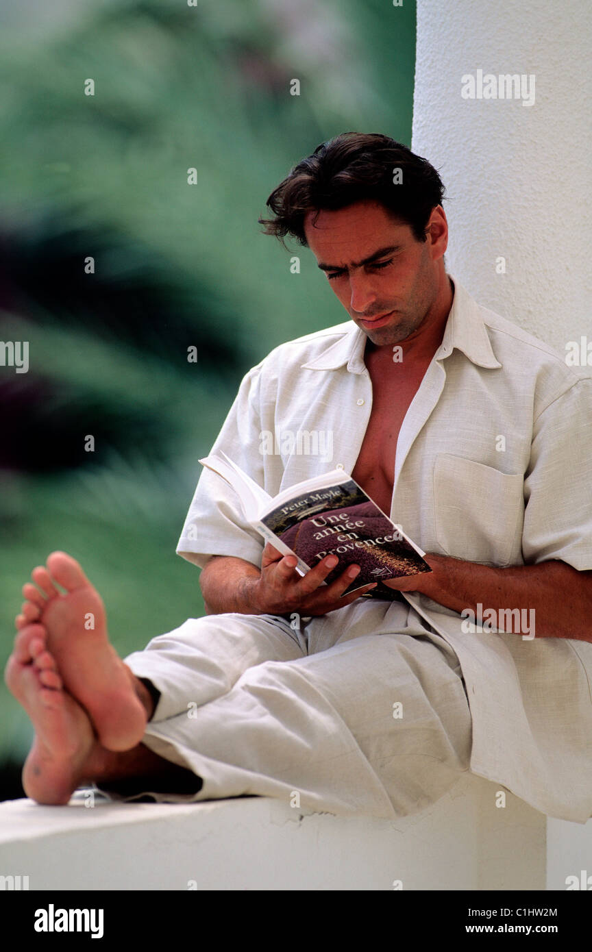 France , Man relaxing and reading Stock Photo - Alamy