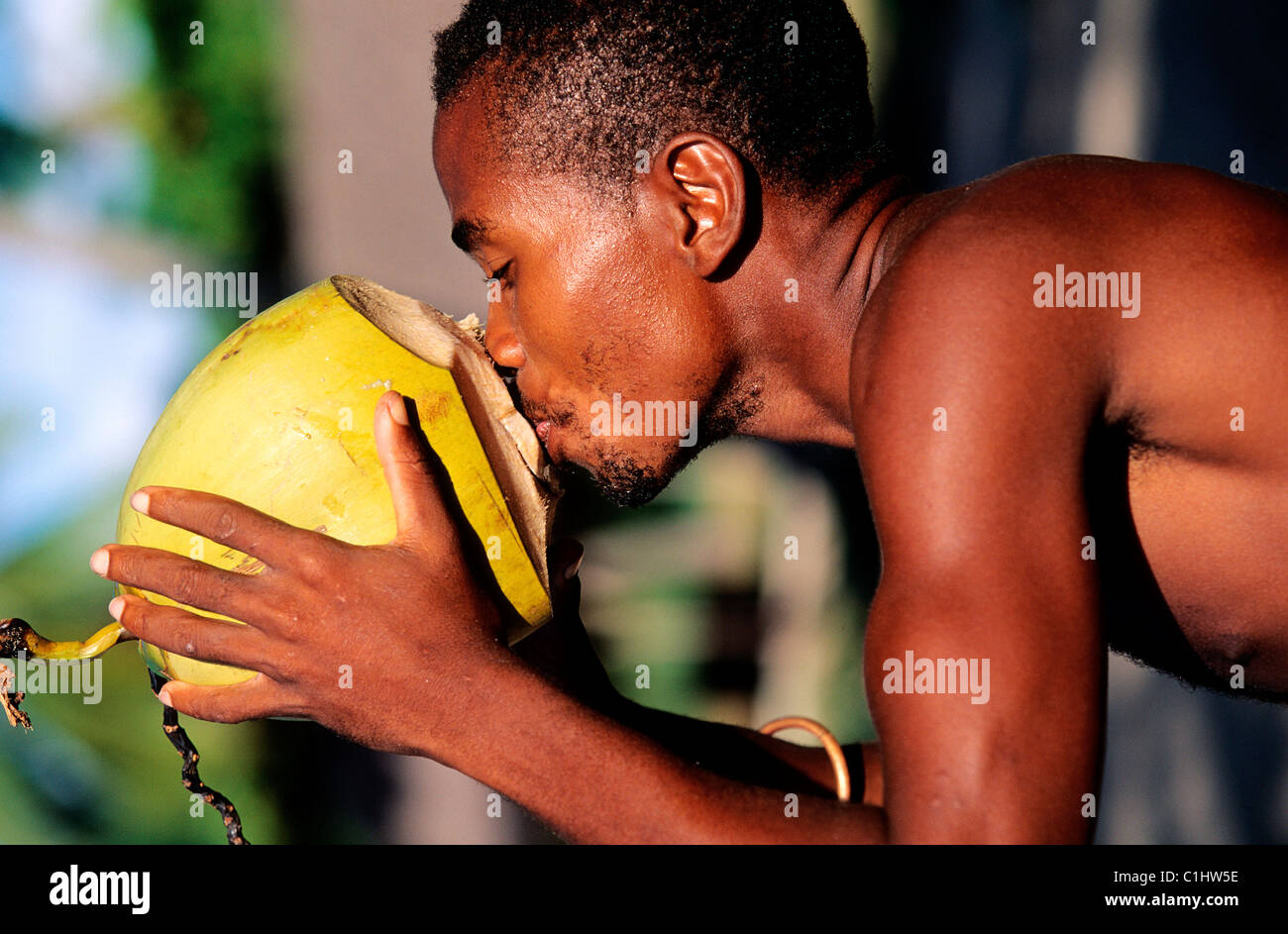 Madagascar, North-western area, Nosy-Be, a man drinking a coconut Stock ...