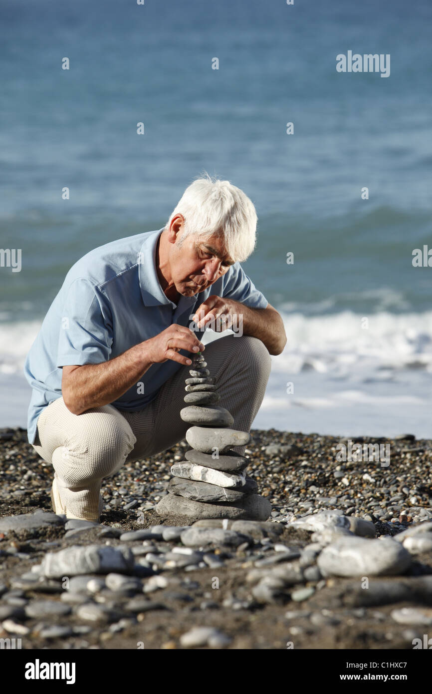 Man stacking stones hi-res stock photography and images - Alamy