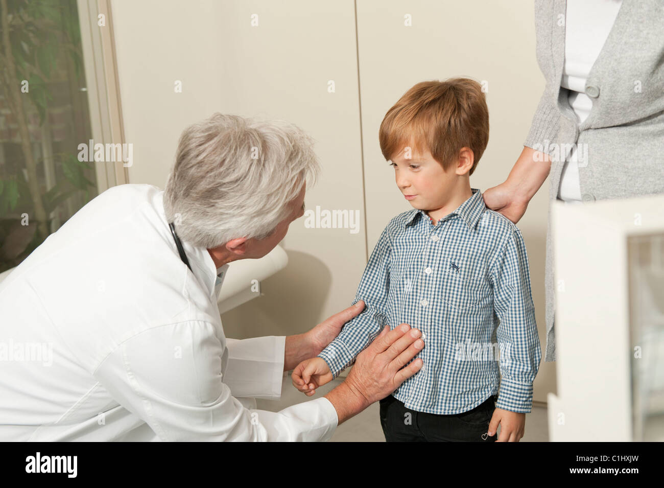 Pediatric senior doctor examining hi-res stock photography and images ...