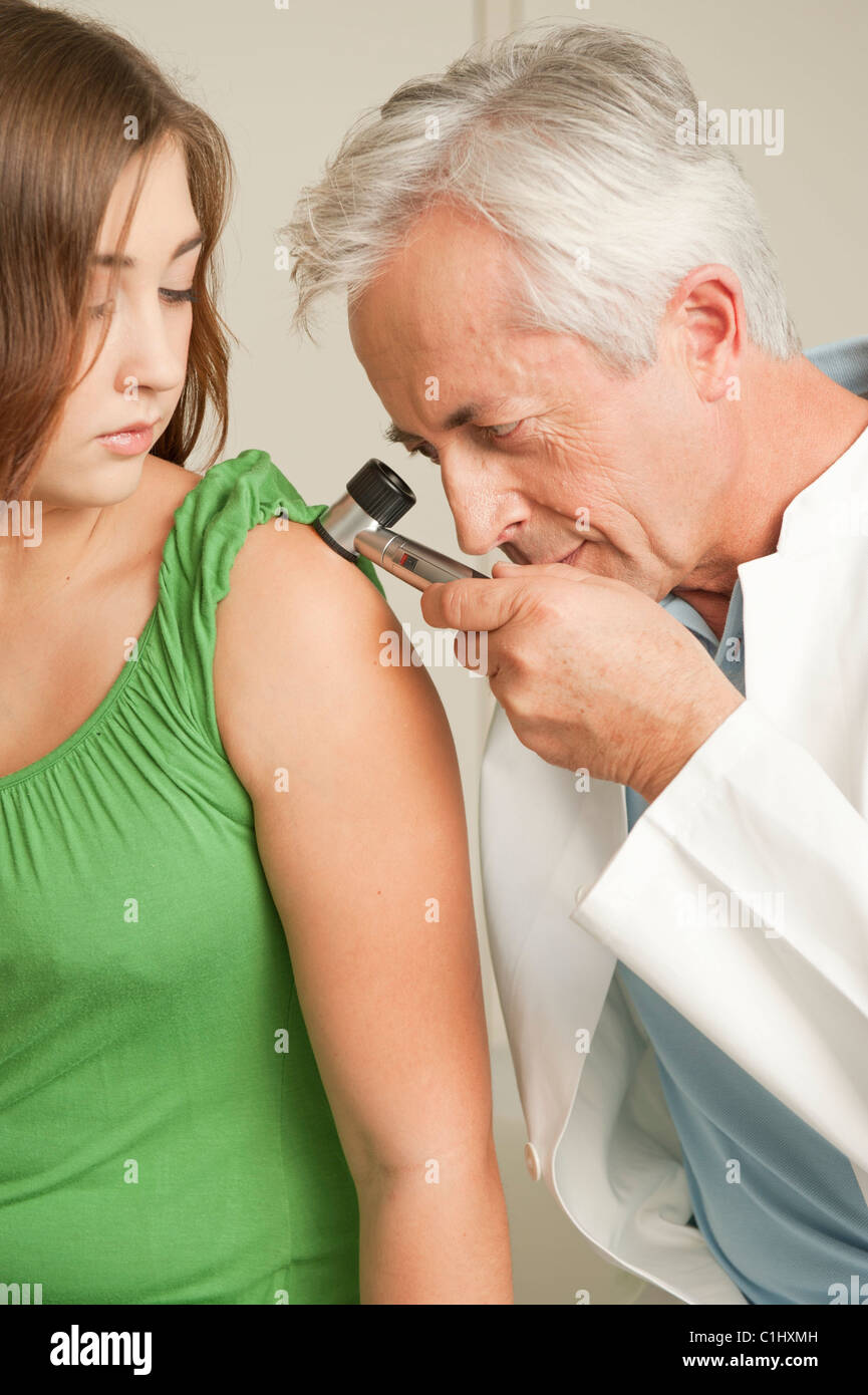 Doctor examining patient's arm Stock Photo - Alamy