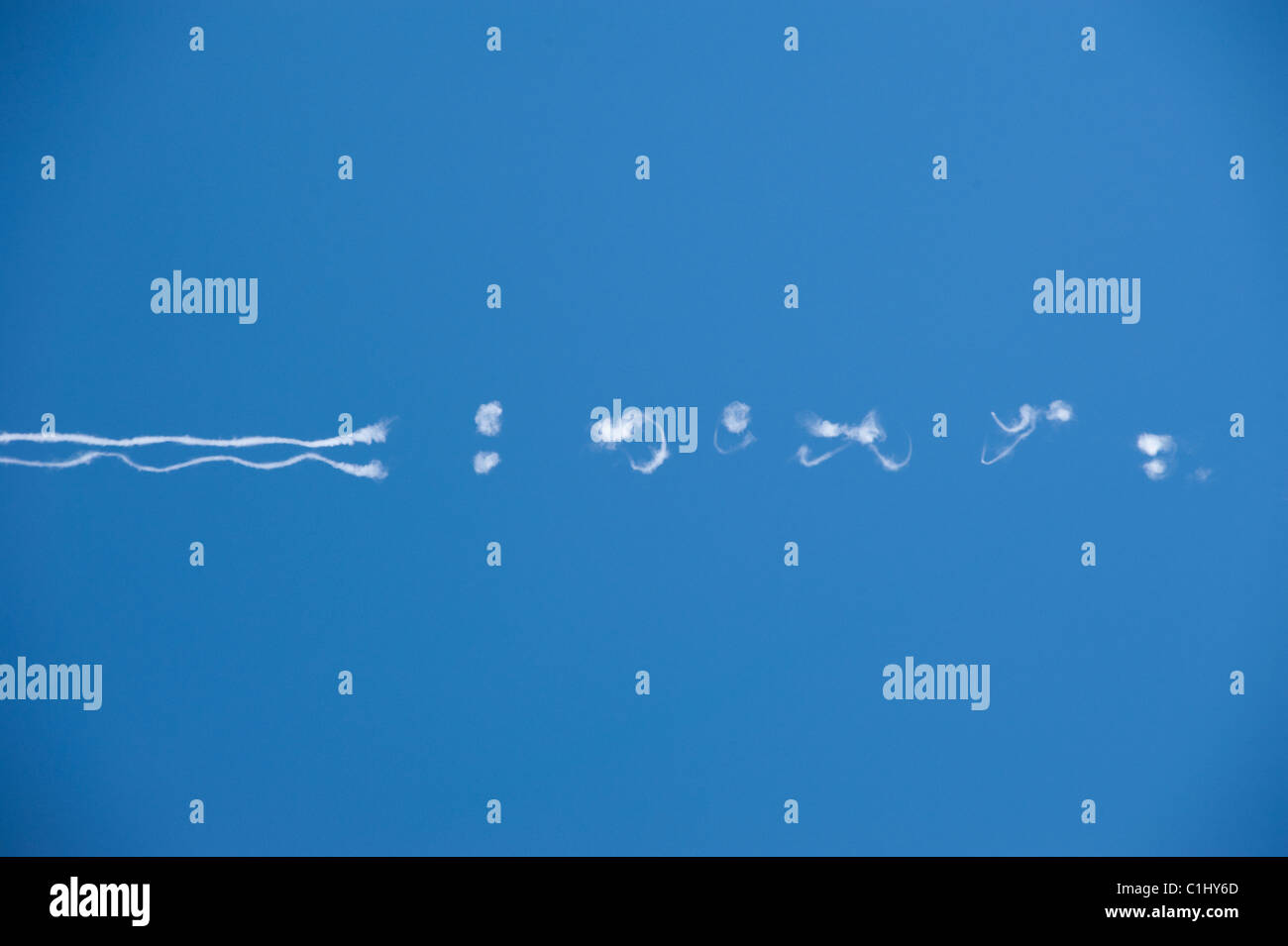 Aircraft vapour (vapor) trails (contrails) breaking up and dispersing ...