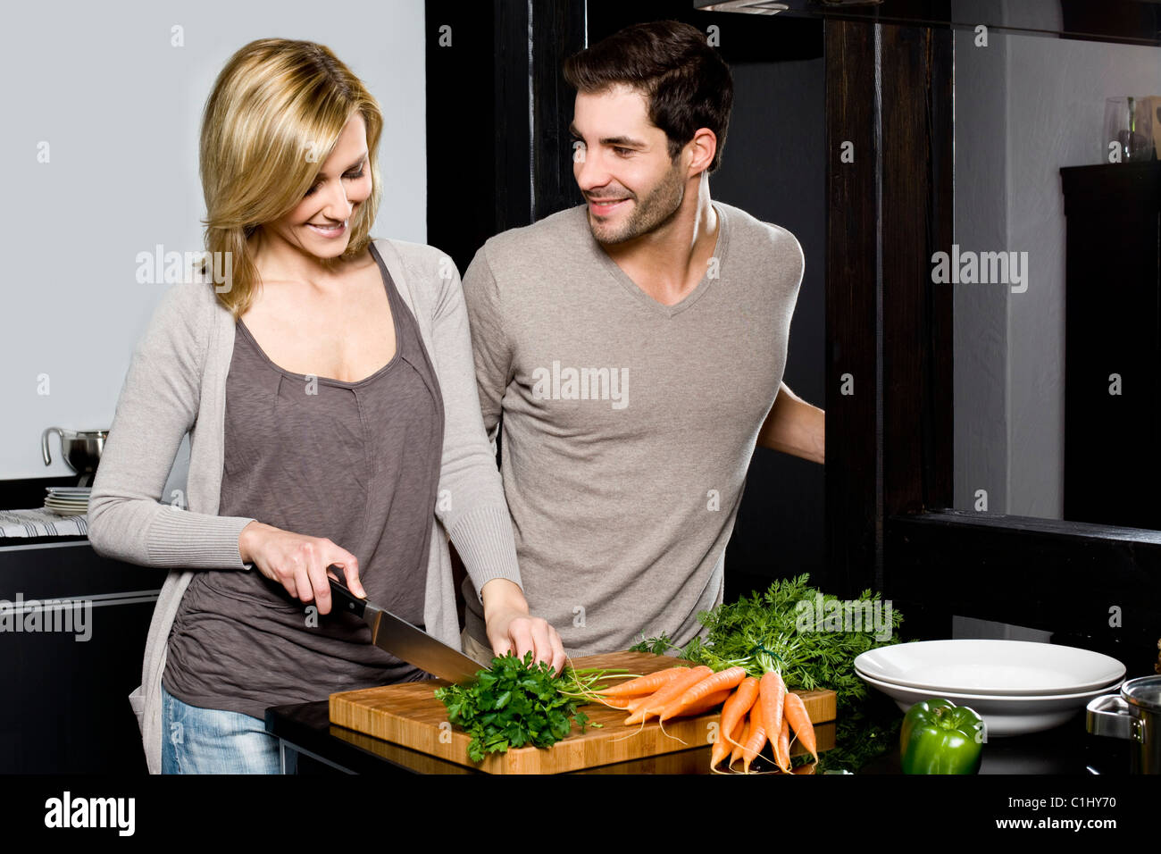 Young couple in kitchen Stock Photo - Alamy