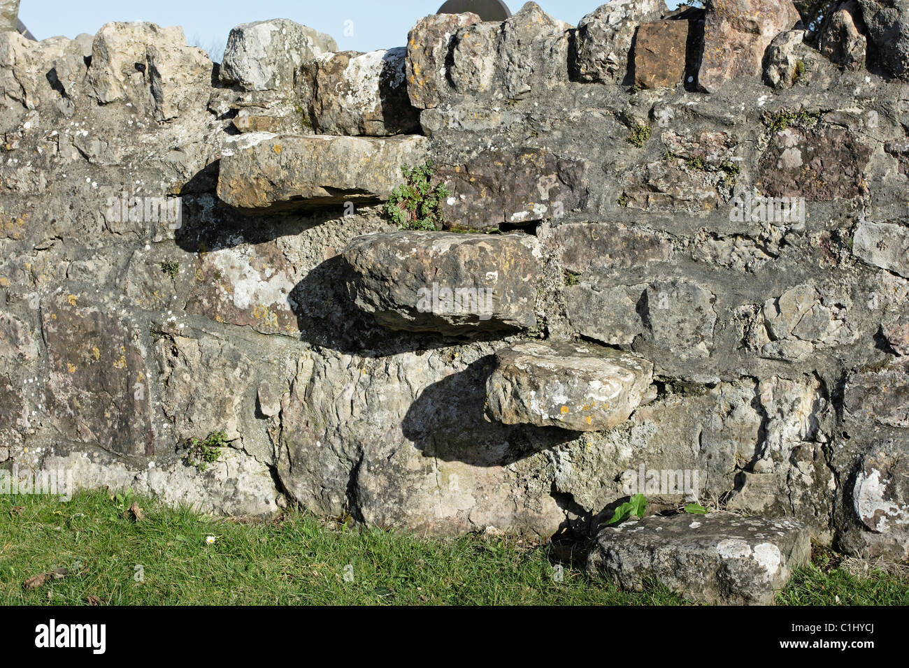 An old fashioned stone style across a stone wall Stock Photo - Alamy