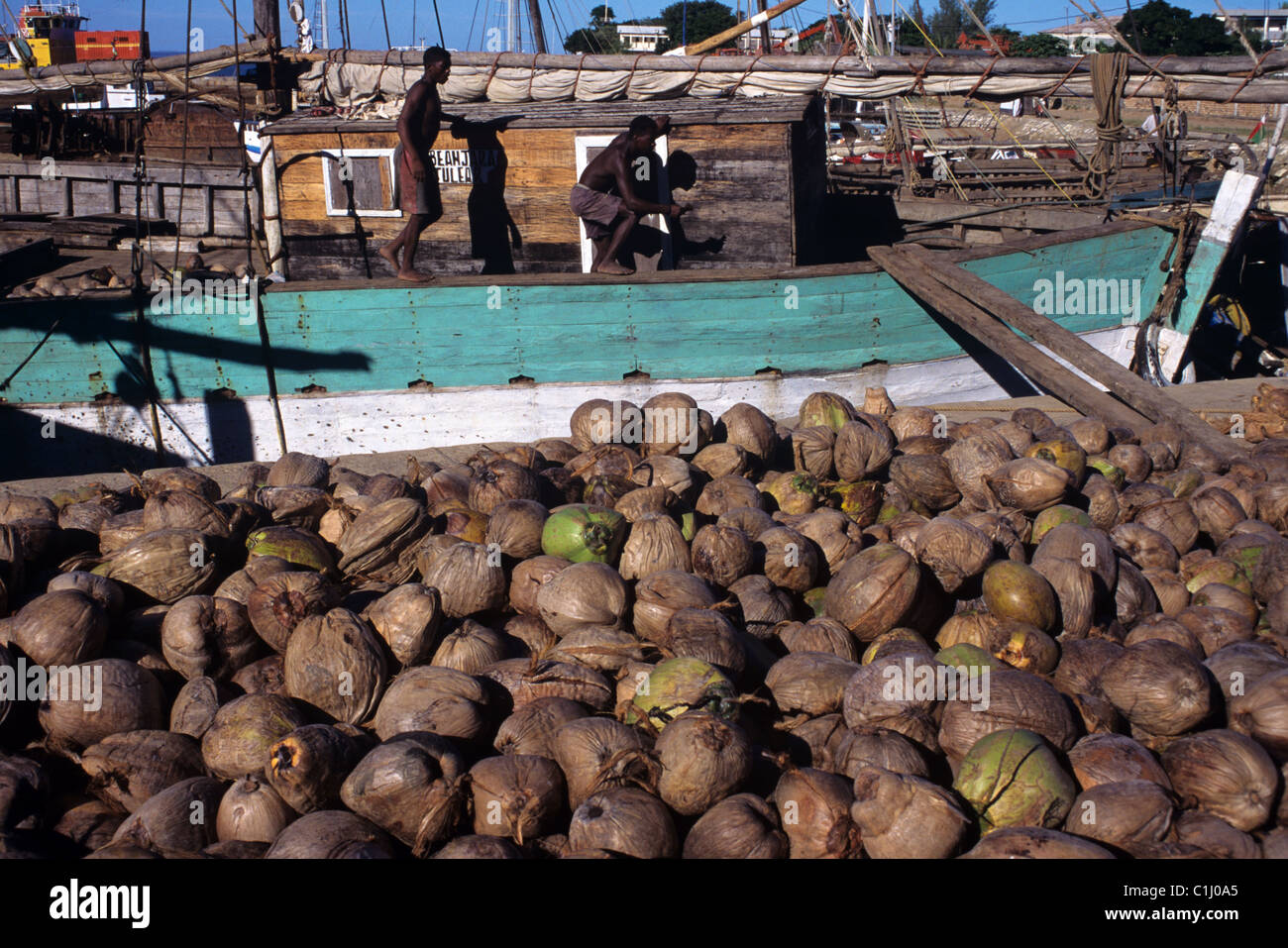 Unloading Cargo of Coconuts from Wooden Dhow on Quay or Quayside ...