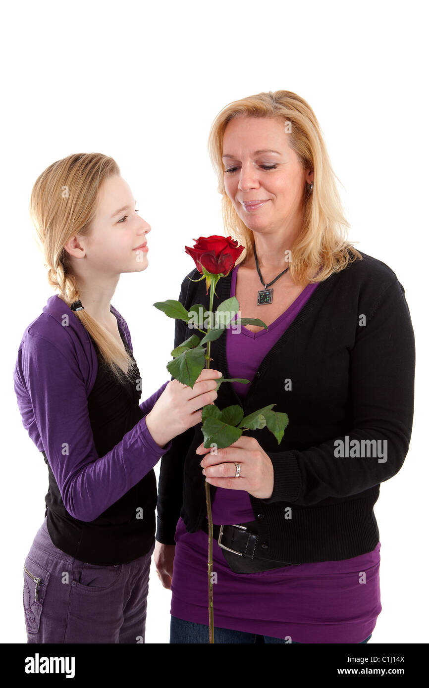 Young girl gives rose to mother over white background Stock Photo - Alamy